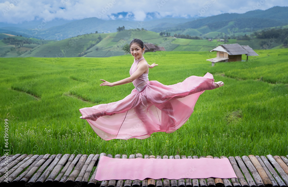 Ballerina jumping doing a split. Young girl doing classical dance near ...