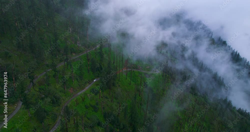 Forward-moving drone shot of Forest fog Nepal, White clouds, 4x4 Jeep ...