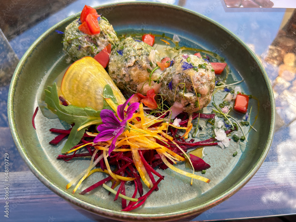A dish of canederli or Knodel in with orange carrots, typical pasta or ...