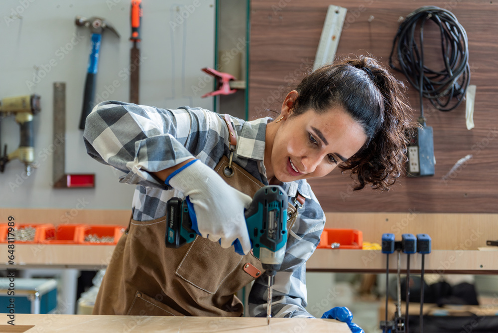 One Strong confident young aged women carpenter standing aim at wood ...