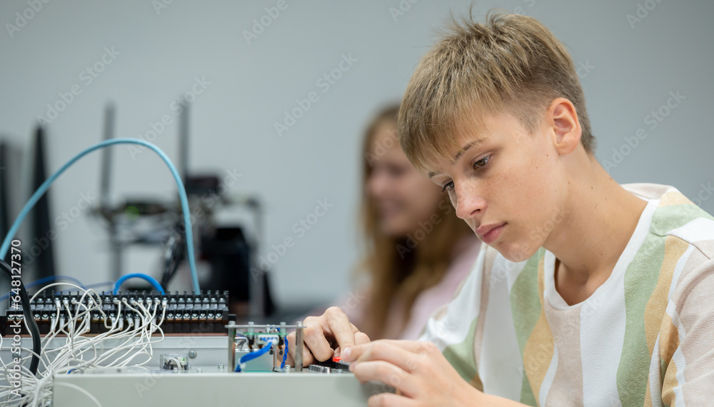 Boy male teen child concentrate enjoy Machine Learning Robot is Moving ...