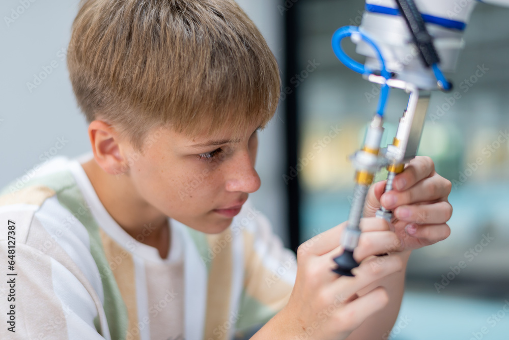 Boy male teen child concentrate enjoy Machine Learning Robot is Moving ...