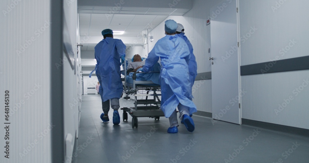 Doctors, nurses and paramedics run and push stretcher with seriously ...