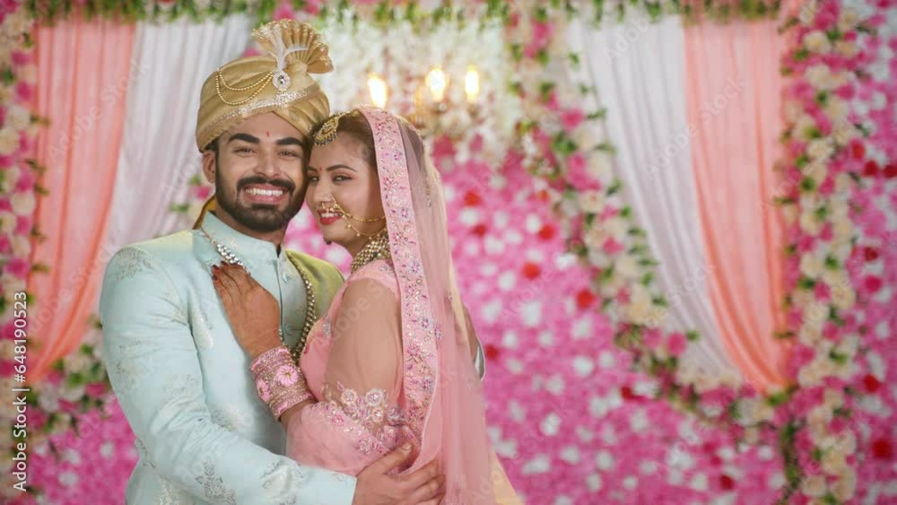 Happy Indian newlywed Couple or bride and groom posing to camera by ...