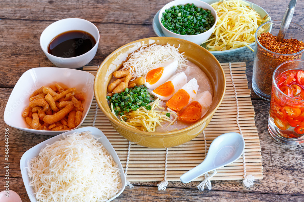 Congee, rice porridge with salted egg, leek, and ginger. Asian healthy ...