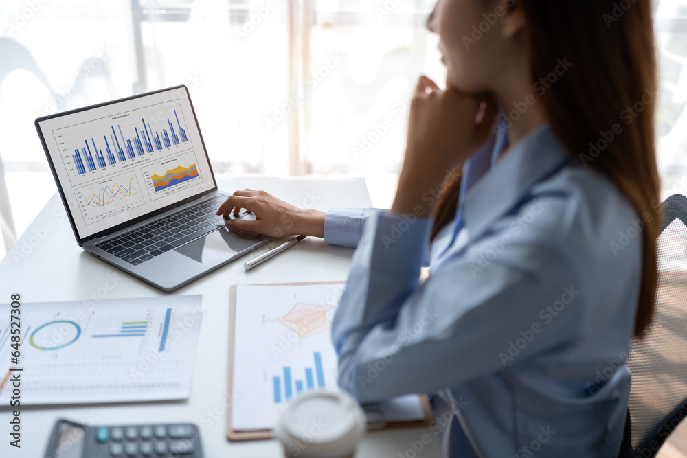 Asian businesswoman sitting and thinking analyze financial reports ...