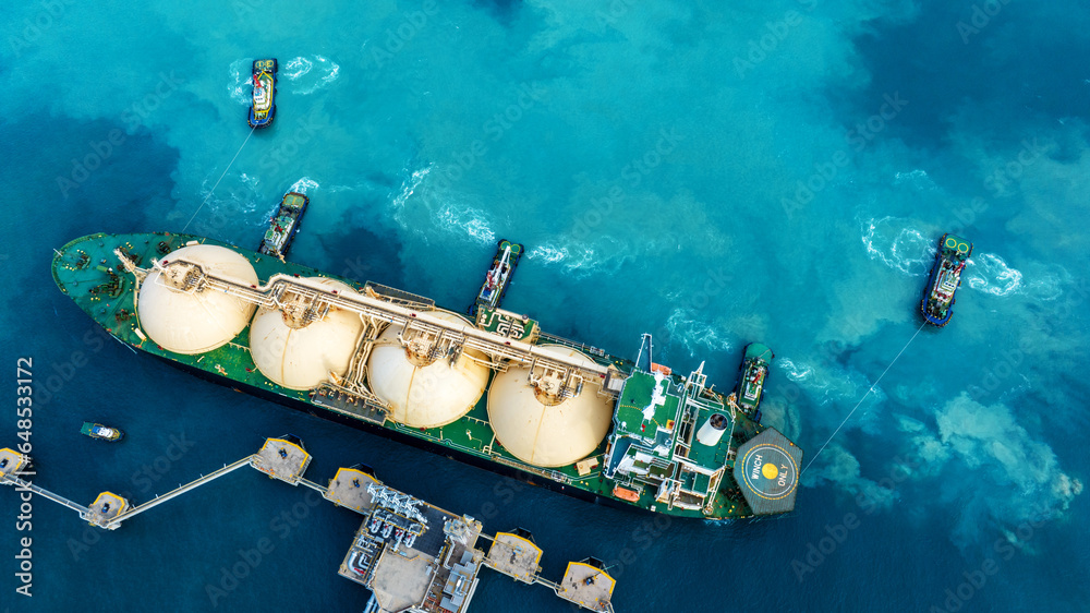 LNG (Liquefied natural gas) tanker anchored in Gas terminal gas tanks ...