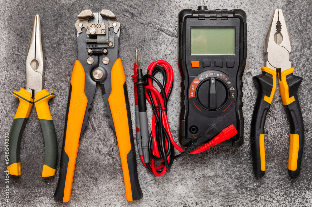 Electrician tools on black marble background.Multimeter,construction ...