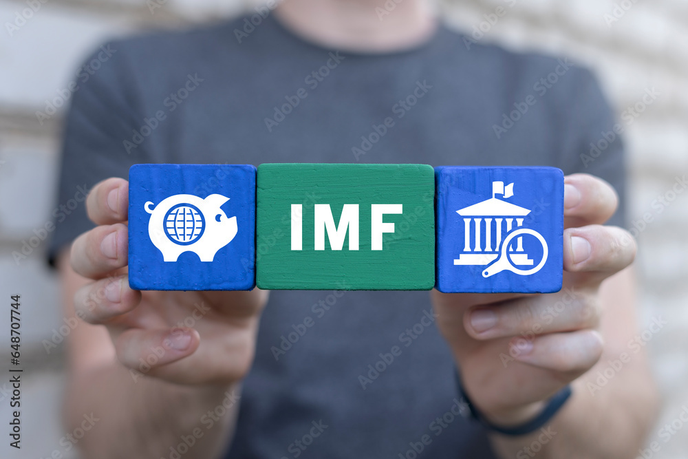 Man holding colorful blocks sees acronym: IMF. IMF International ...
