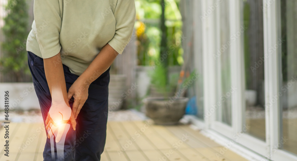 Sick unhappy senior adult elderly asian woman touching her muscle ...