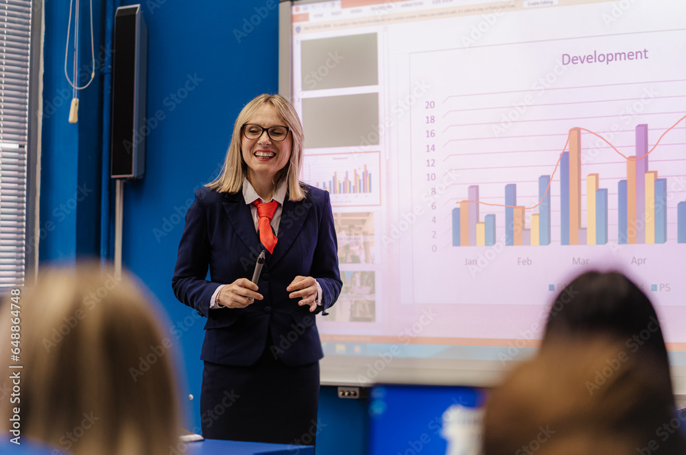 Happy, smiley, positive, university professor giving lecture to a group ...