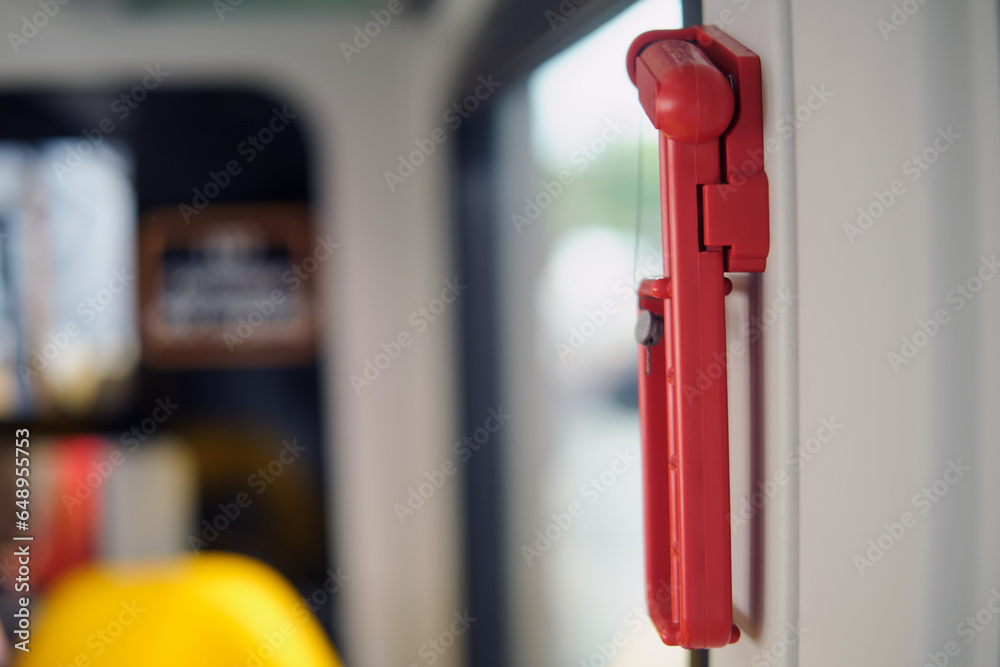 Hammer window glass breaker on the train, tram, bus and car. Red safety ...