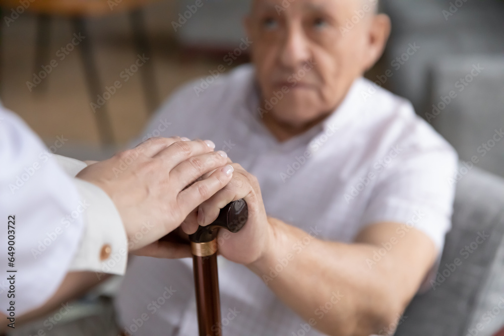 Caring nurse hold hands support comfort sick disabled senior 80s male ...