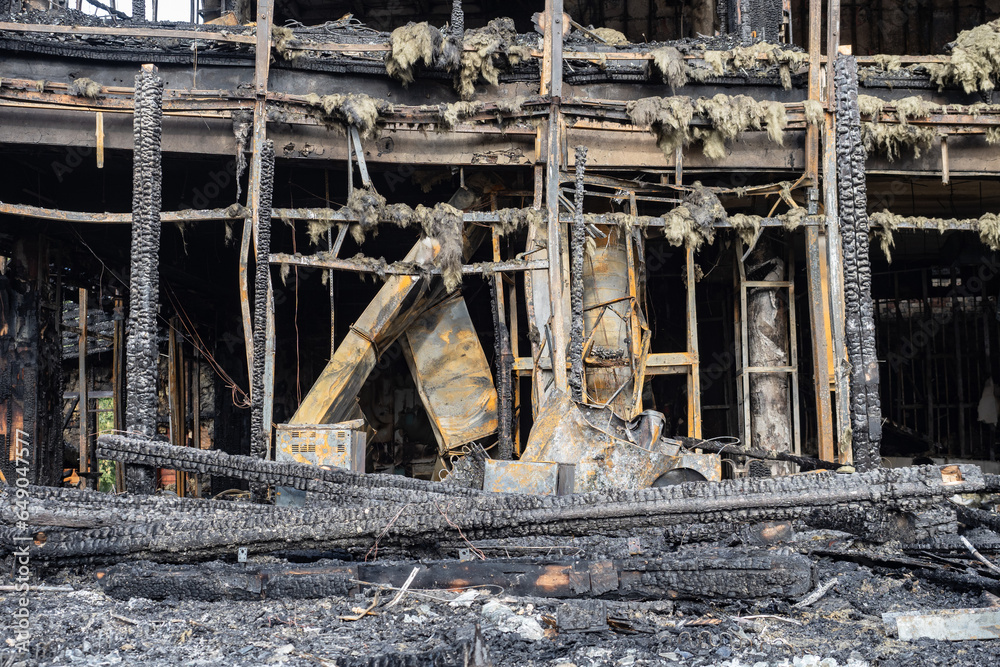 Ruins burnt building. Charred construction. External view burnt ...