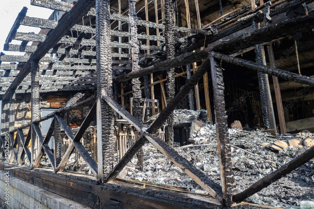 Remains burnt house. Ruins building damaged by flame. Charred frame ...
