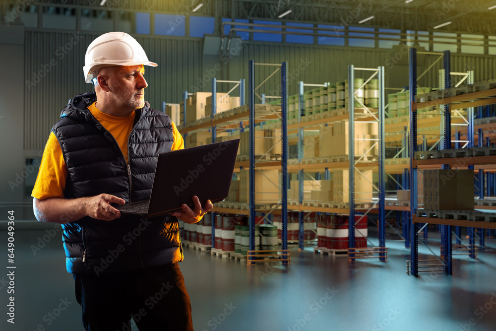 Warehouse specialist. Man with laptop in storage. Worker in warehouse ...