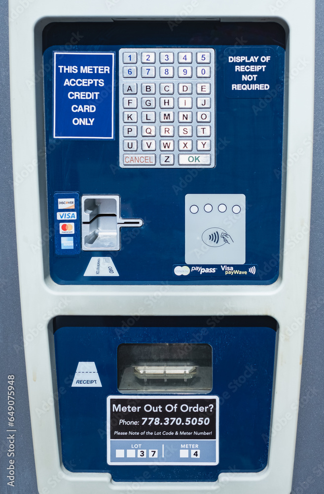 Ticket machine at the exit of a car park. An autamated parking ticket ...