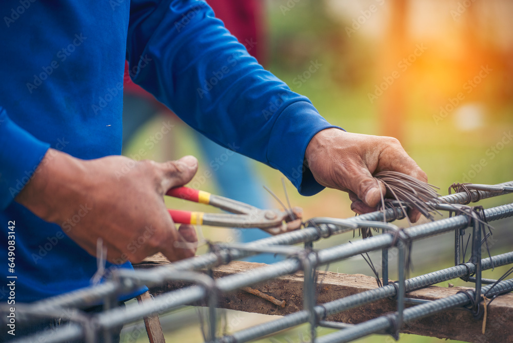 Construction Worker hands using pincer pliers iron wire. Outdoor Worker ...