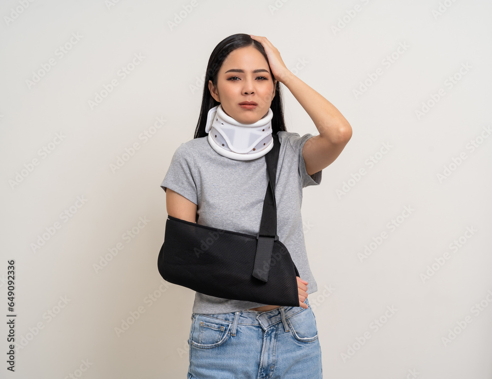 Depressed upset woman suffering from pain. Broken arm. Asian woman put ...