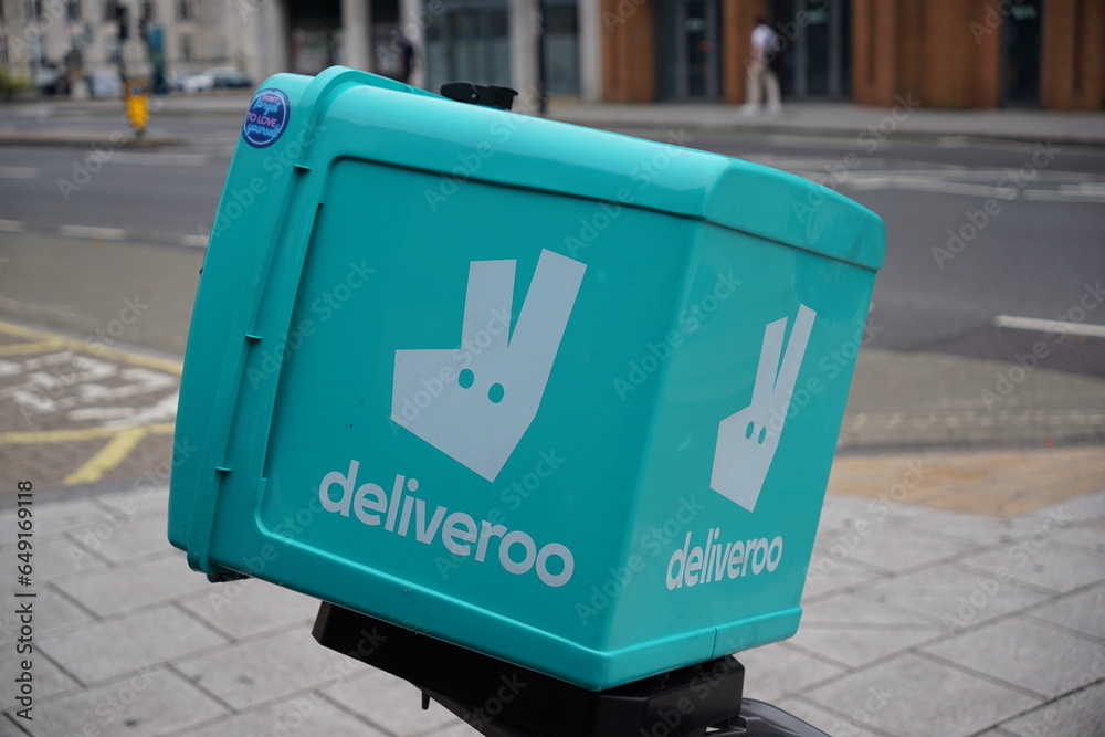 Southampton, UK 12 September 2023 - Deliveroo logo on delivery scooter box. Takeaway and grocery ...