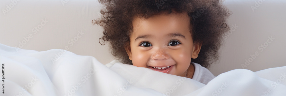 Cute litle black african baby with afro hair wrapped in soft white ...