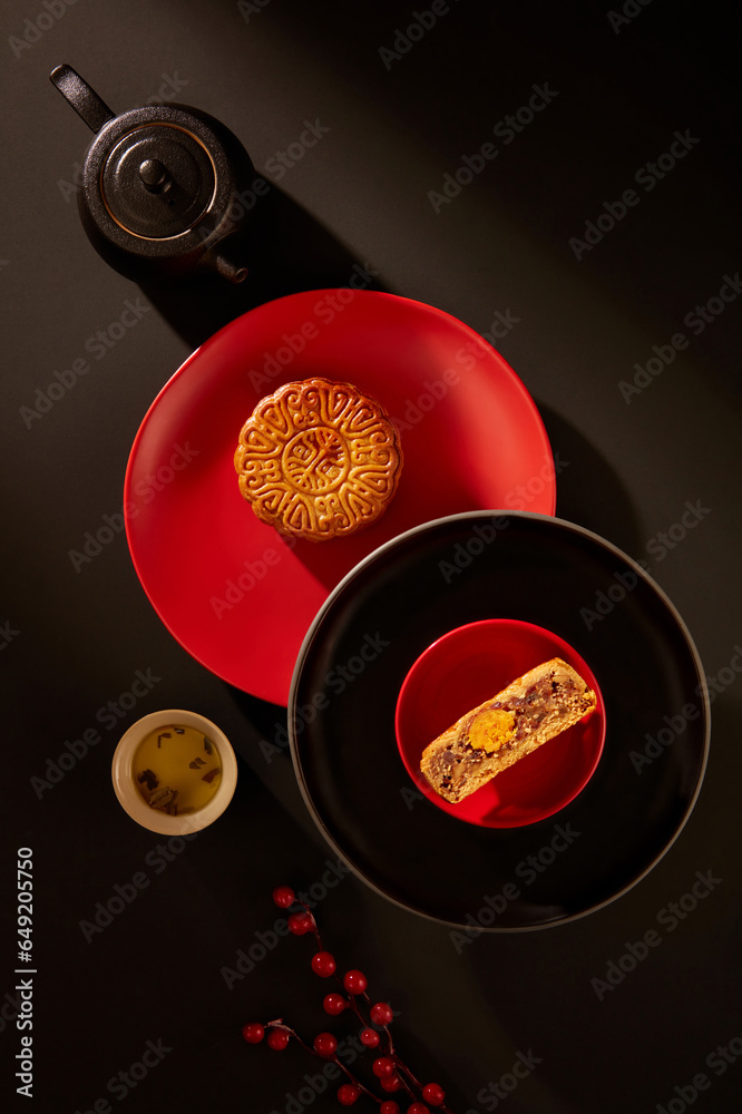 Overhead view of delicious mooncakes on color dishes with set of tea ...
