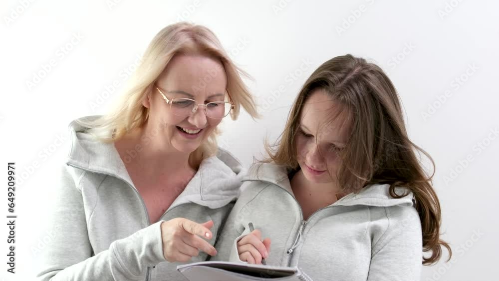 mom and daughter doing homework, woman wearing glasses, young teenage ...