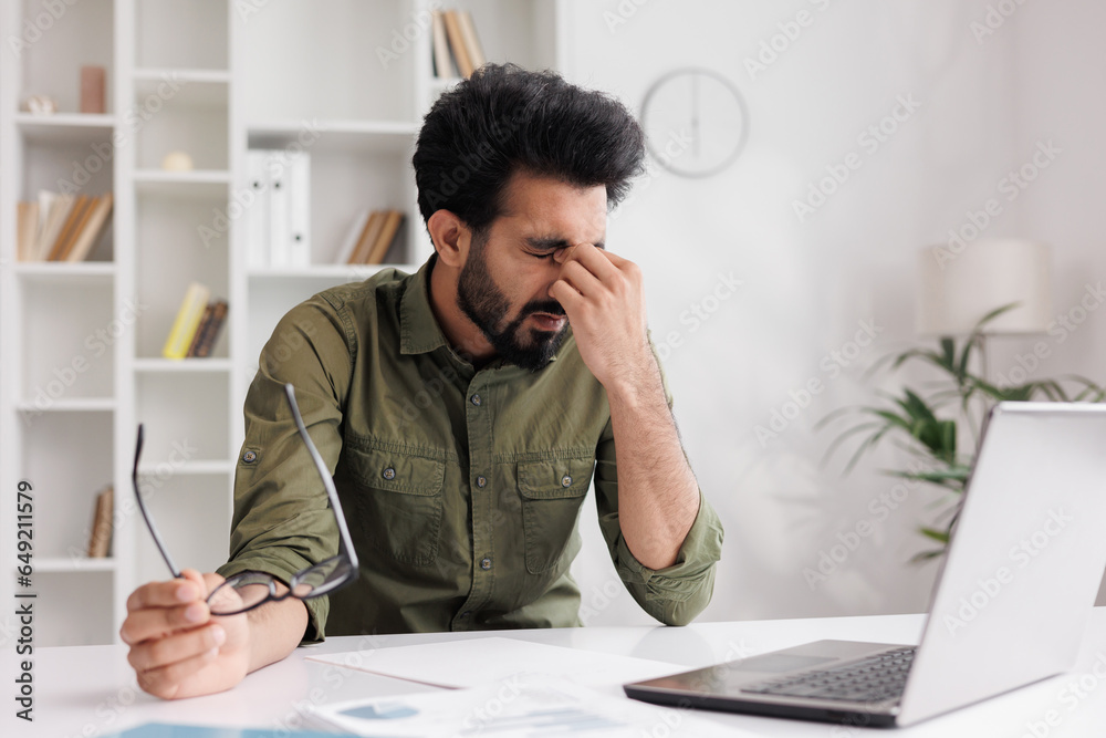 Tired Indian man takes off glasses, suffers from painful sensations ...