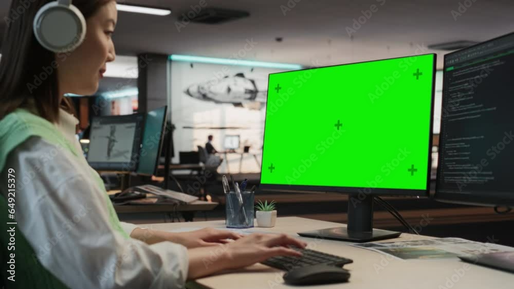 Female Asian Game Programmer Coding On Desktop Computer With Green Screen Chromakey On Display ...