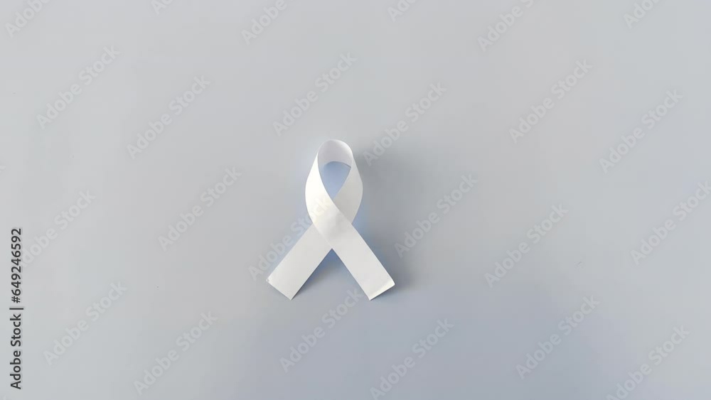 White ribbon as a symbol of peace on a blue background. World Day of ...