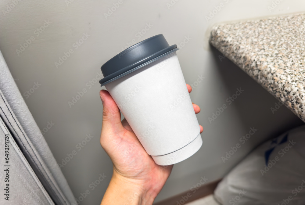 Recyclable paper cup, a symbol of eco-consciousness, sits on green ...