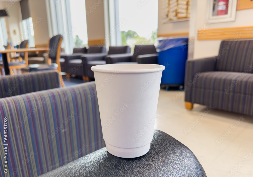 Recyclable paper cup, a symbol of eco-consciousness, sits on green ...