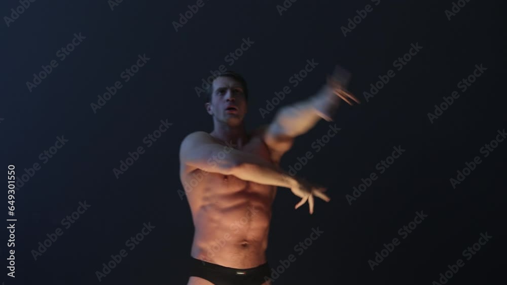 A muscular athlete in an epic pose, fog and smoke on the background ...
