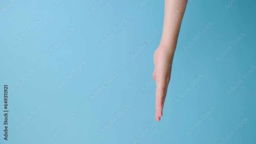 Vertical footage of female hand isolated on blue background. Empty open ...