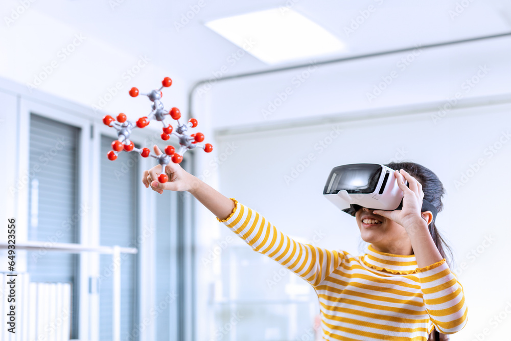 Girl using VR glasses learning molecular model chemistry science at home. Child Wearing ...