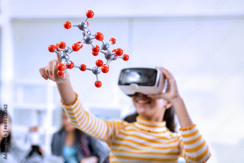 Girl using VR glasses learning molecular model chemistry science at home. Child Wearing ...