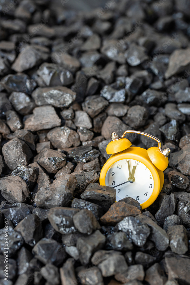 clock with an alarm for the twelve o'clock furnace lying in a coal heap ...