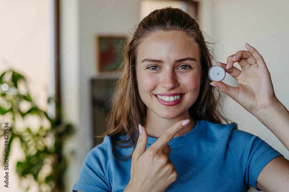 Beautiful diabetic girl pointing at continuous glucose monitor. Stock ...