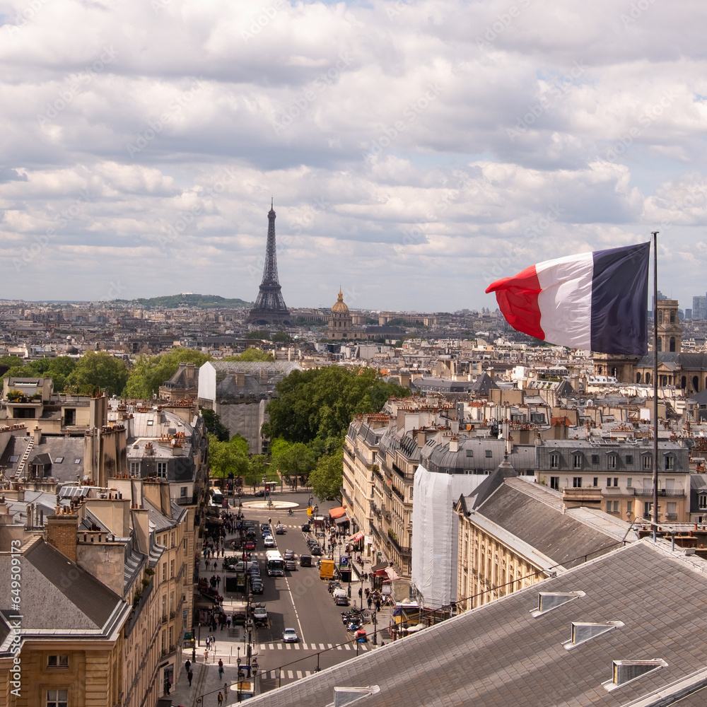 France, Paris, French flag on building roof, Eiffel tower in background ...