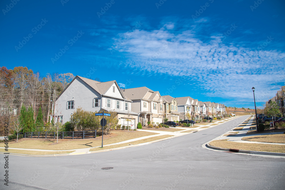 Intersection of large residential streets with row of upscale new ...