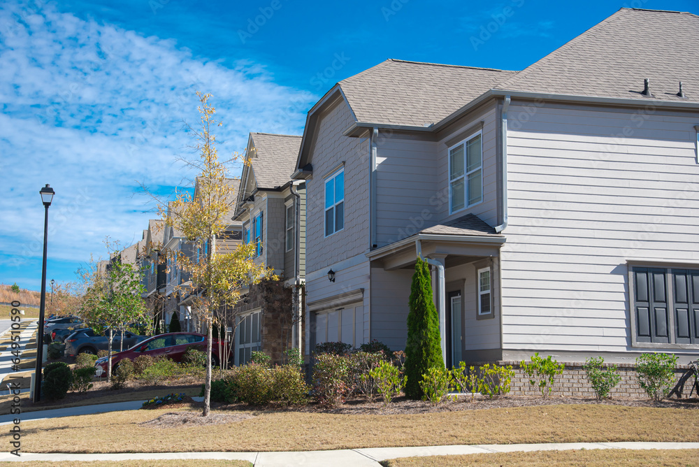 Corner two story houses by large residential streets intersection in ...