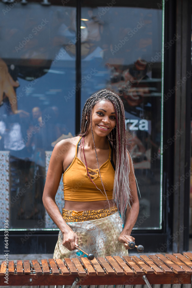 Portrait of a beautiful Afro-descendant woman posing with a traditional ...