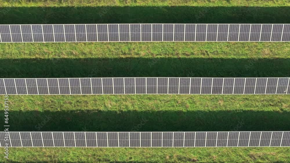 Aerial up close overhead view of large solar farm with many rows of ...
