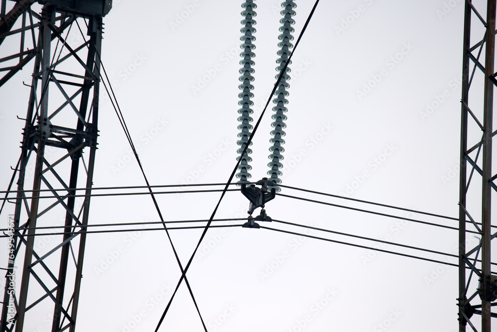 High voltage tower with electric power lines divided by safe guard ...