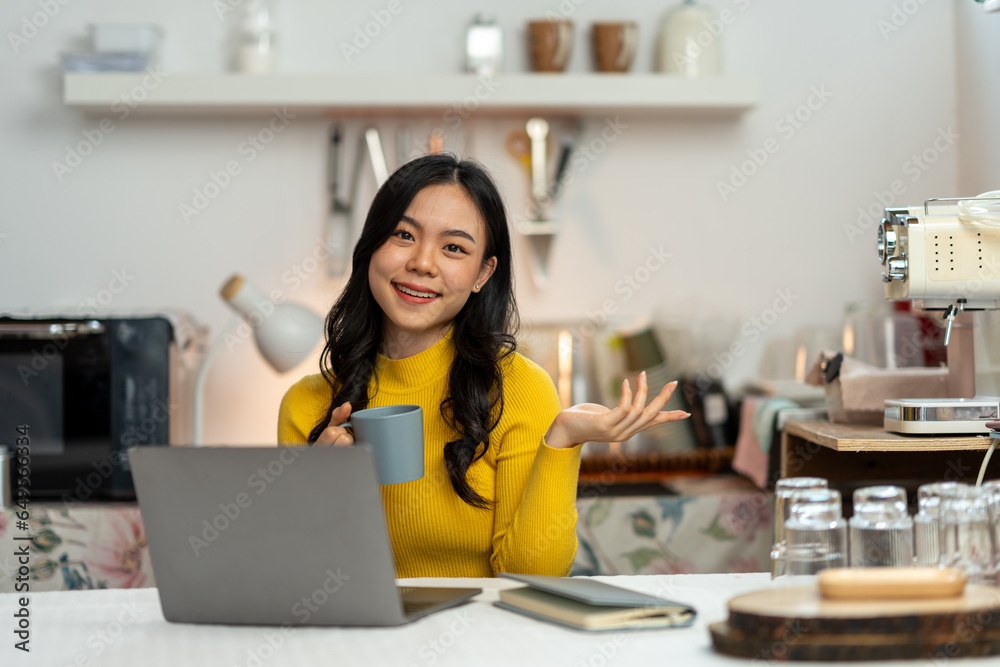 Smiling happy beautiful Asian woman relaxing using technology of laptop ...