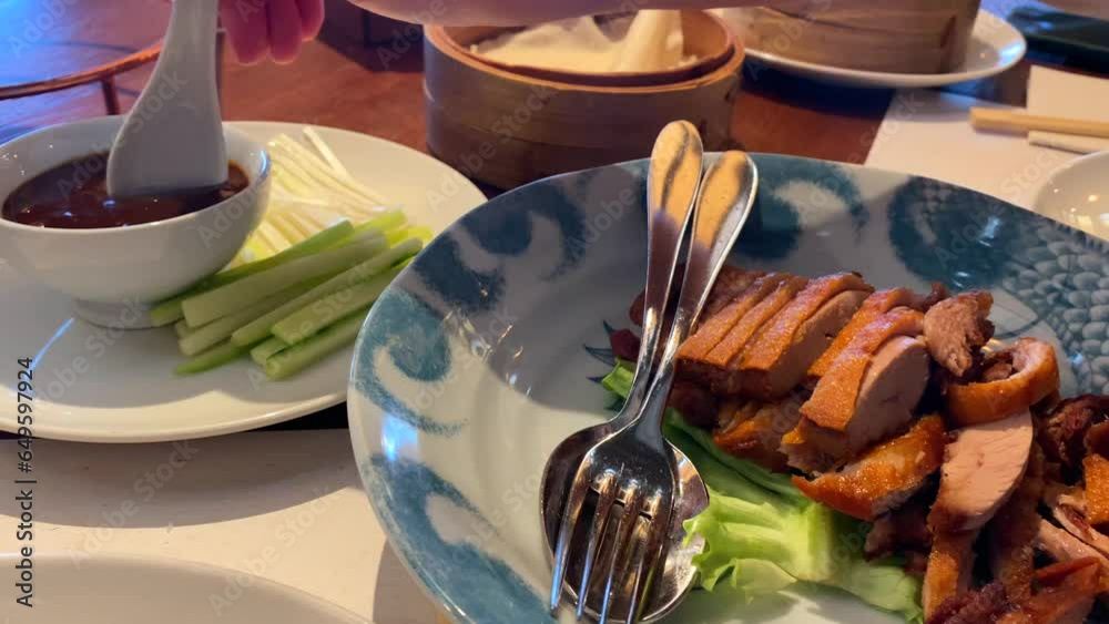 Delicious Peking duck dish with cucumbers, onions, steamed pancakes and ...