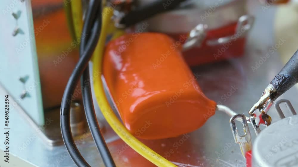 Guitar service concept. Man soldering potentiometer contact on electric ...