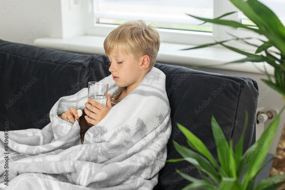 Seasonal cold. Sick preteen boy with high fever and sore throat and ...