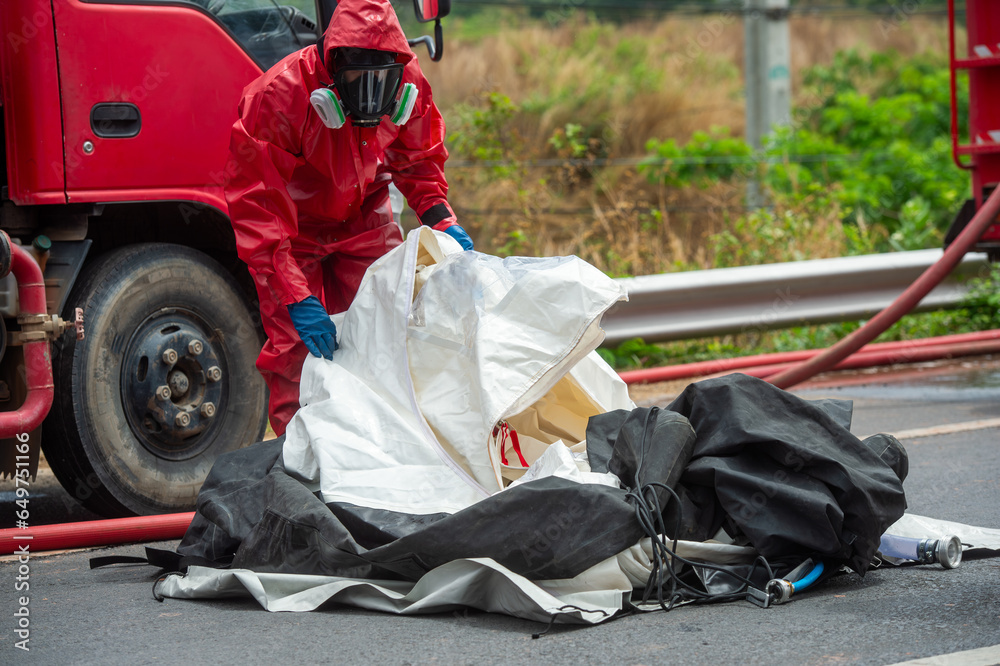 Rescuers wearing red hazmat suits assembled a Inflatable sterilization ...