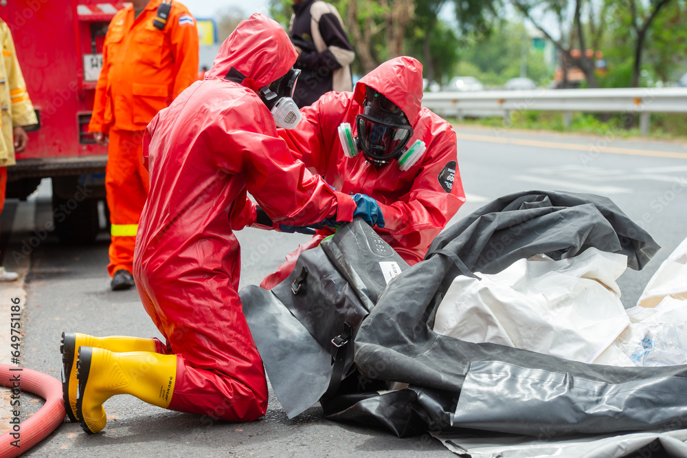 Rescuers wearing red hazmat suits assembled a Inflatable sterilization ...